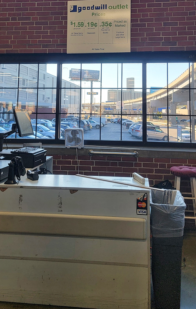 The checkout counter, where dreams are weighed and priced – the pricing board reveals the magnificent truth that clothing costs less than a coffee.