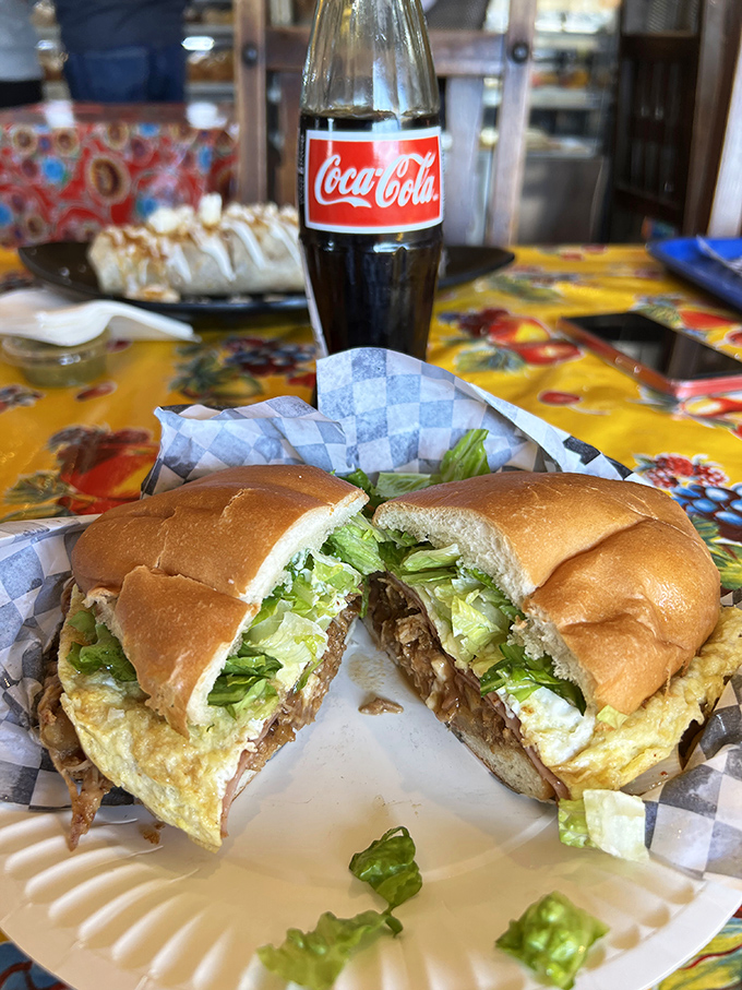 This torta isn't just a sandwich; it's an architectural marvel of meat, cheese, and veggies that requires both hands and zero shame.