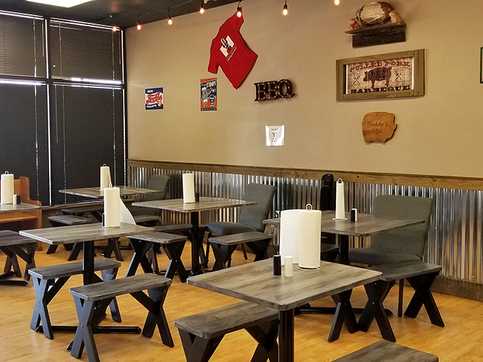 Picnic tables indoors? Genius. The corrugated metal wainscoting says "we're serious about barbecue, not fancy tablecloths."