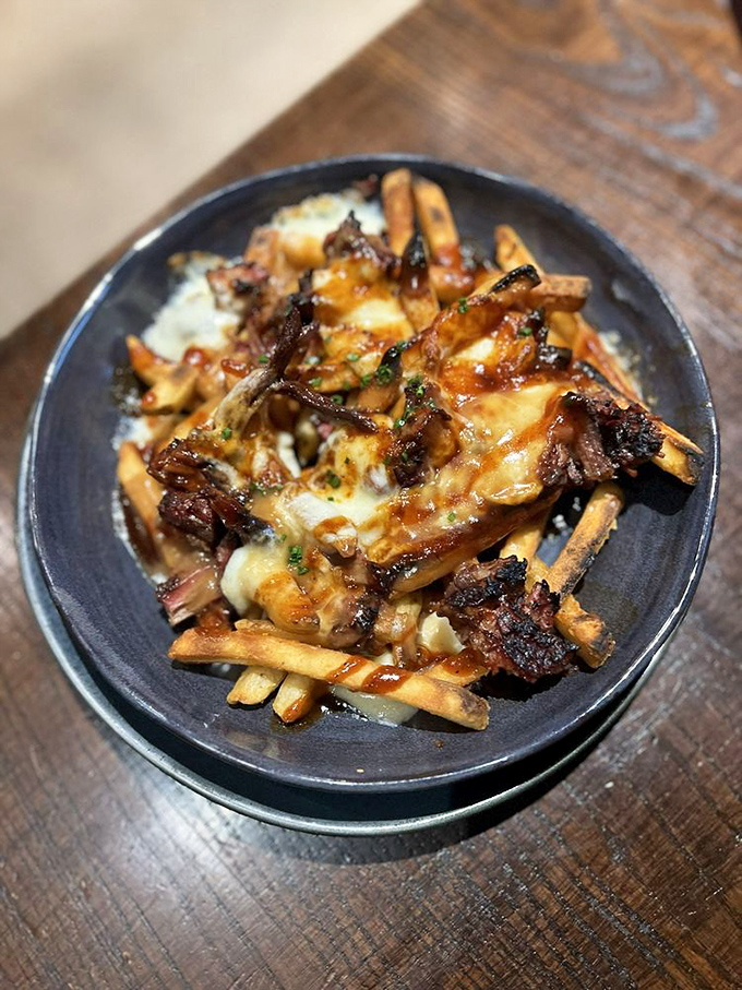 These loaded fries aren't simply a side dish; they're an achievement in culinary architecture—brisket, cheese, and sauce creating a monument to excess.