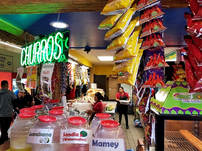 The neon churro sign beckons like a lighthouse for the sweet-toothed. Fresh fruit aguas frescas in rainbow jars promise refreshment after hours of exploration.