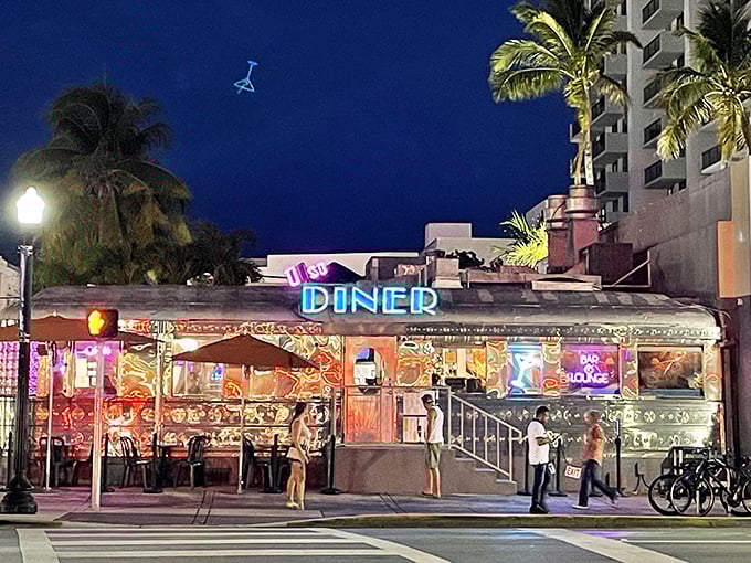 As night falls, the diner's neon glow becomes a beacon for hungry night owls and those seeking refuge from South Beach's glitzy excesses.