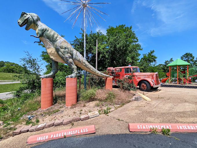 A fearsome dinosaur statue guards the entrance, setting the tone for the wonderfully weird experience waiting just beyond the parking lot.