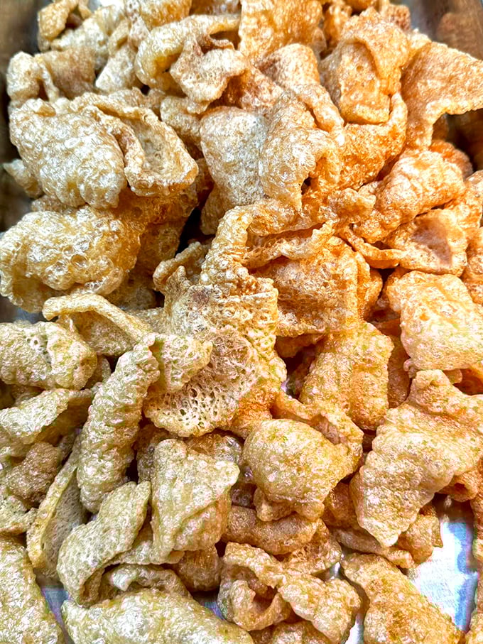 These pork rinds aren't just a snack, they're a Southern art form – airy, crunchy clouds of porky perfection that dissolve on your tongue.