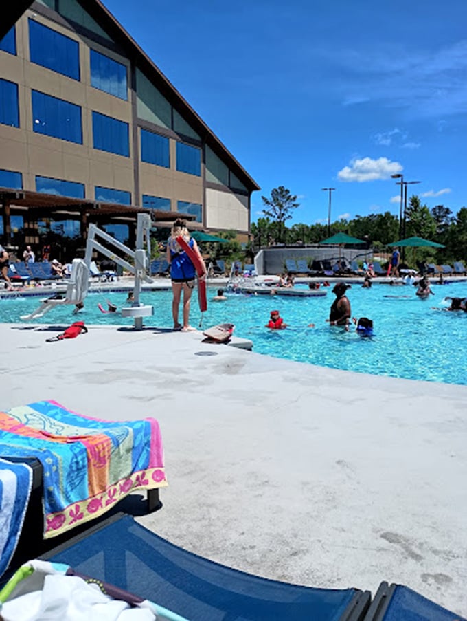 The exterior view showcases the resort's impressive architecture alongside the outdoor pool area – rustic lodge meets aquatic playground.
