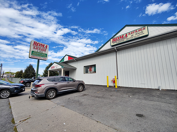 Roma's retro signage stands tall against the big blue sky, a beacon for sandwich seekers venturing upstate.