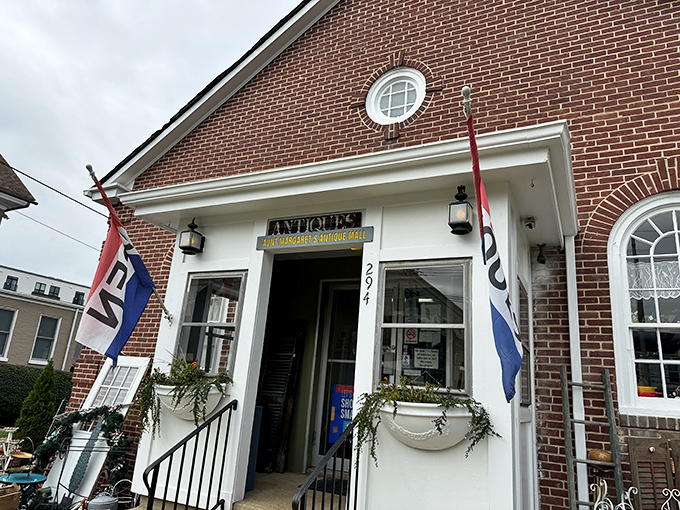 The charming brick exterior of Aunt Margaret's beckons with its round window and vintage lanterns—like a time portal disguised as a building.