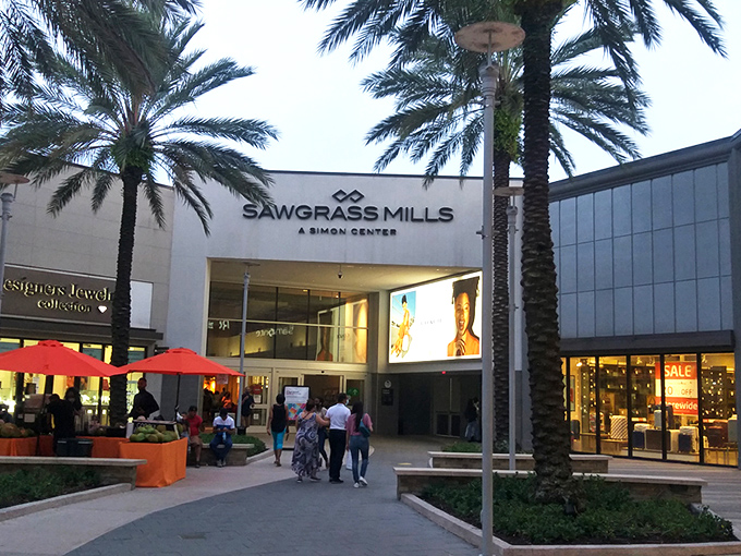 Palm trees frame the entrance to Sawgrass Mills like nature's own welcome committee. Florida shopping doesn't get more iconic than this retail oasis.