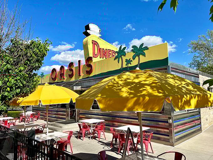 The sunshine-yellow exterior of Oasis Diner beckons like a time portal to the 1950s, complete with palm trees that seem hilariously optimistic in Indiana weather.