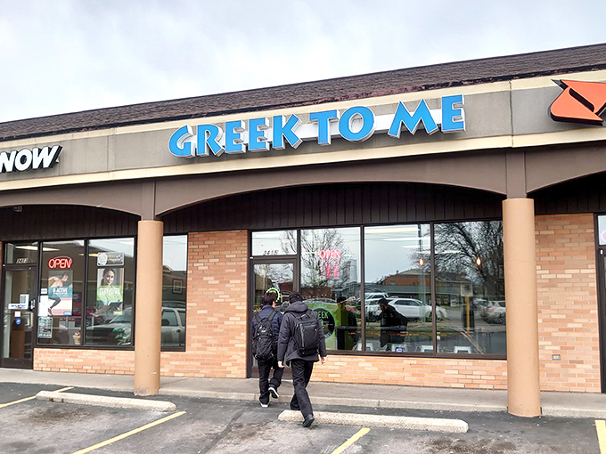 The bright blue sign beckons like a Mediterranean lighthouse in a sea of strip mall sameness. Kentucky's answer to Athens awaits inside.