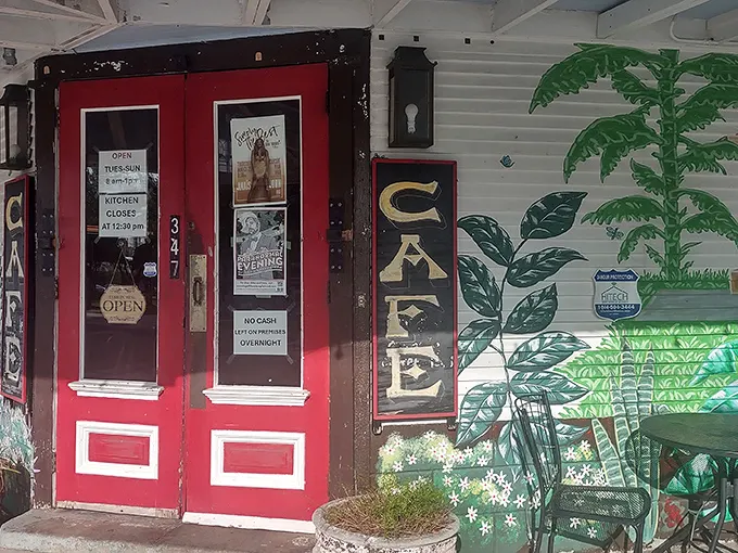 The corner cafe with its iconic red doors and palm tree murals stands like a breakfast beacon in Algiers Point, inviting hungry souls to step inside.