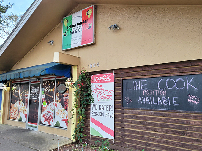 The welcoming facade of Italian Garden beckons hungry travelers with its cheerful signage and cozy entrance. A hidden gem waiting to be discovered.