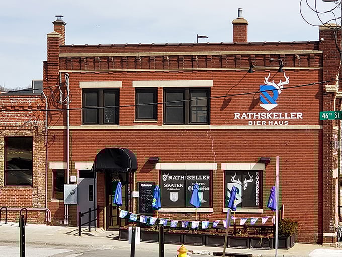 The brick exterior of Rathskeller Bier Haus stands proudly in Omaha, complete with Bavarian blue and white flags fluttering in the Nebraska breeze.