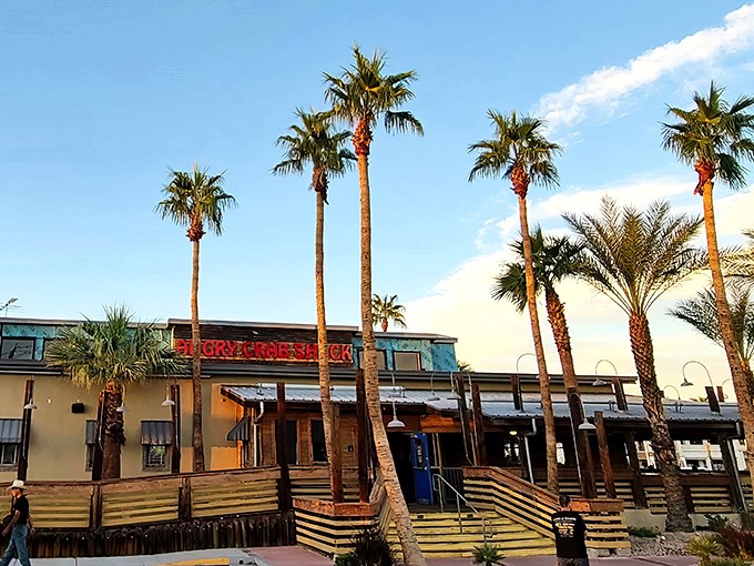 Palm trees and wooden ramps welcome you to seafood paradise—where the desert meets the ocean at Angry Crab Shack's inviting Henderson location.