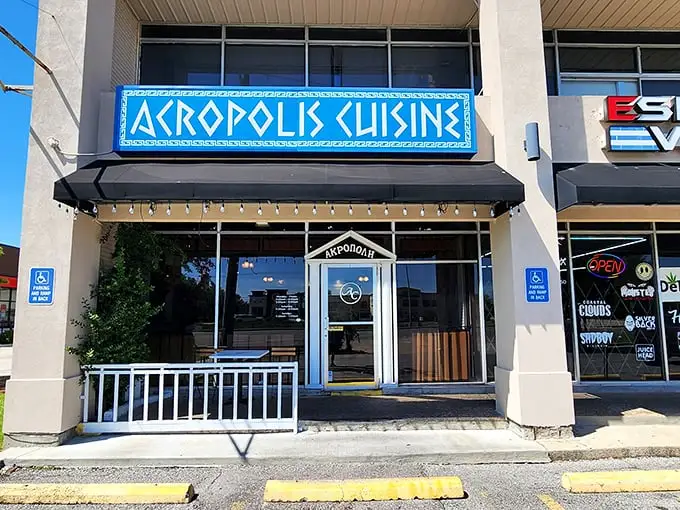 The bright blue sign of Acropolis Greek Cafe stands out like a Mediterranean beacon in New Orleans, promising authentic Greek flavors just steps away.
