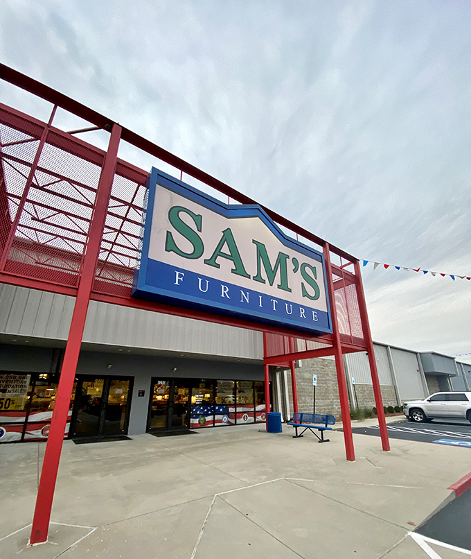 The iconic red entrance of Sam's Furniture stands out like a Broadway marquee, complete with a patriotic inflatable tube man welcoming shoppers to the furniture wonderland.