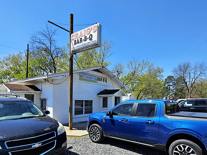 The unassuming white building with its vintage sign promises more than meets the eye. Barbecue pilgrims know: the humbler the exterior, the better the meat inside.