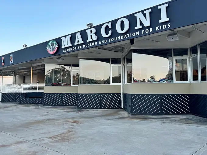 The unassuming exterior of Marconi Automotive Museum belies the treasures within, like finding a Ferrari dealership hiding behind what looks like your accountant's office.