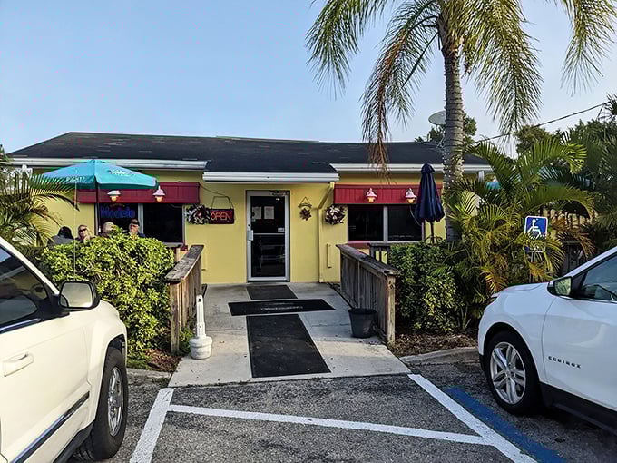 The cheerful yellow exterior with pink awnings isn't just inviting—it's practically shouting "breakfast is served!" Palm trees and a wooden deck complete this slice of Florida comfort.