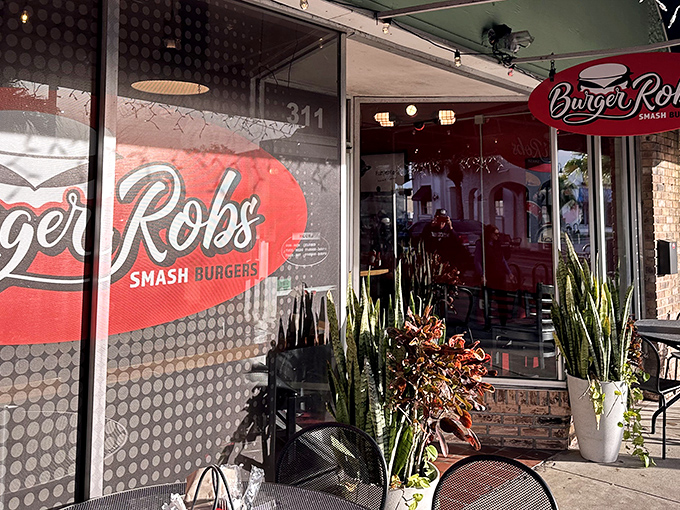 The unassuming storefront of BurgerRobs in Titusville beckons with its red signage and outdoor seating—a burger sanctuary hiding in plain sight.