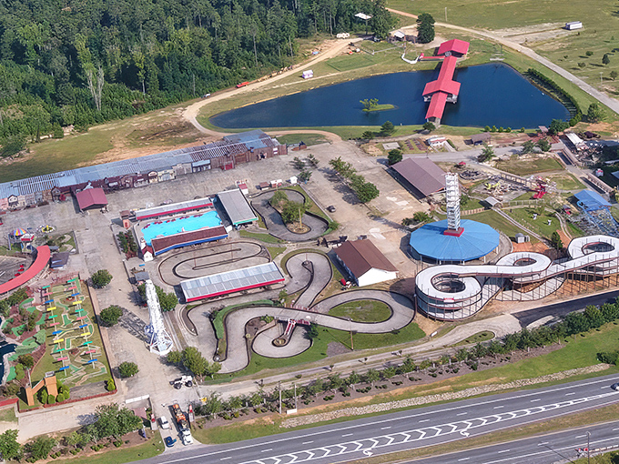 Bird's-eye view of Fun Spot America reveals go-kart tracks, water features, and classic rides nestled in Georgia's landscape – compact joy personified.