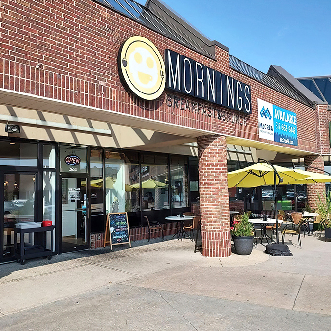 The cheerful yellow smiley face logo seems to know something you don't yet—that breakfast nirvana awaits behind those brick walls.