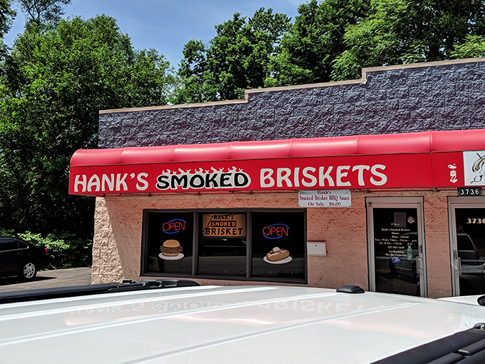 The bright red awning of Hank's stands out like a beacon for barbecue pilgrims, promising smoky salvation inside this unassuming Indianapolis treasure.