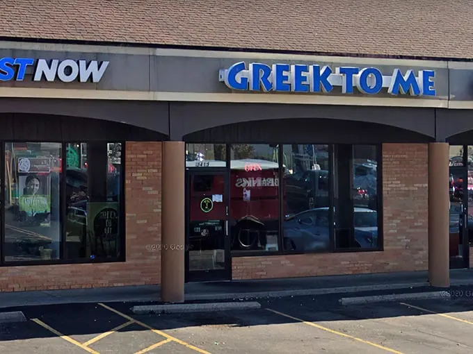The bright blue sign beckons like a Mediterranean lighthouse in a sea of strip mall sameness. Kentucky's answer to Athens awaits inside.