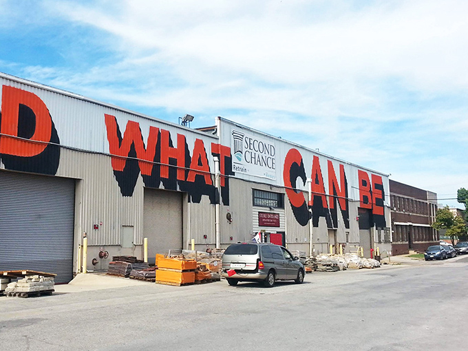 The warehouse with "WHAT" emblazoned across it isn't asking a question—it's making a statement about possibility and transformation.