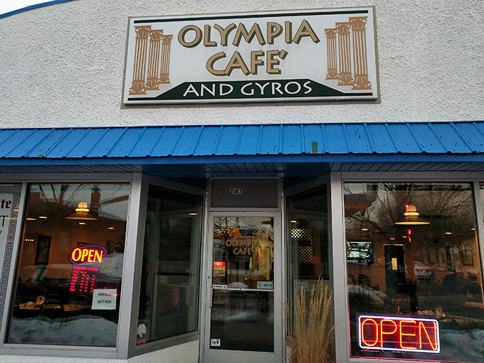 The blue-trimmed facade of Olympia Cafe beckons like a Mediterranean mirage in suburban Osseo, promising Greek delights and all-day breakfast adventures.