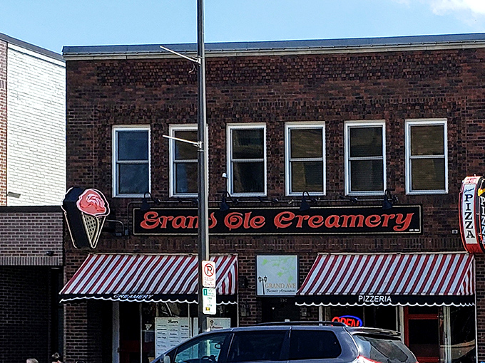 The iconic brick façade of Grand Ole Creamery, with its vintage striped awnings and neon ice cream cone sign, beckons sweet-toothed pilgrims from across Minnesota.