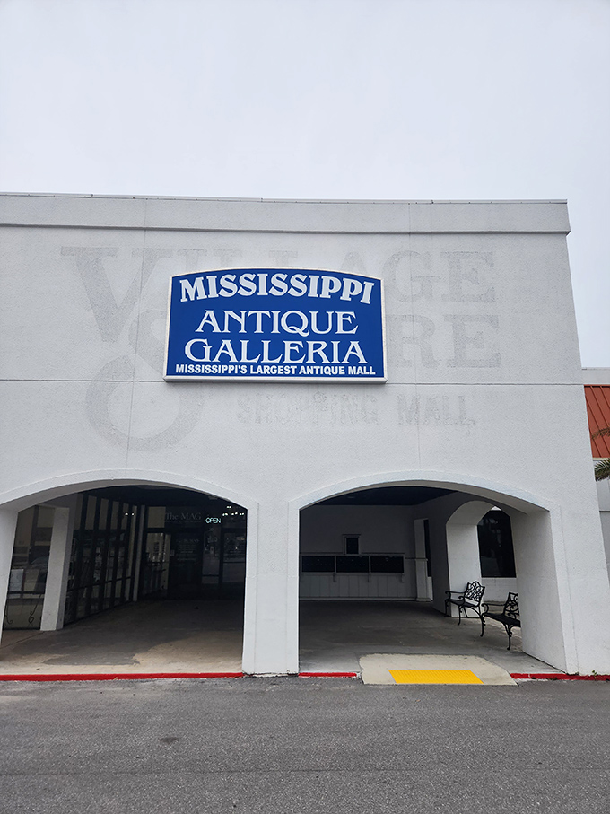 The classic car parked outside isn't just decoration—it's a time machine preview of the wonders waiting inside Mississippi Antique Galleria. 