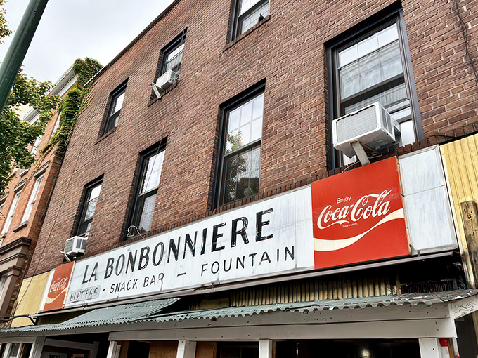 La Bonbonniere's weathered façade stands as a time capsule in the West Village, its vintage sign promising the holy trinity of comfort: burgers, snacks, and fountain treats.