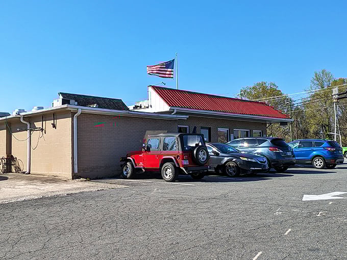 The iconic shield-shaped sign beckons like a time machine disguised as a roadside beacon. Classic Americana awaits inside!