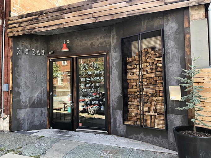 The industrial-chic exterior with its caged firewood display isn't just Instagram bait—it's a smoky promise of what awaits inside. Meat destiny calls. 