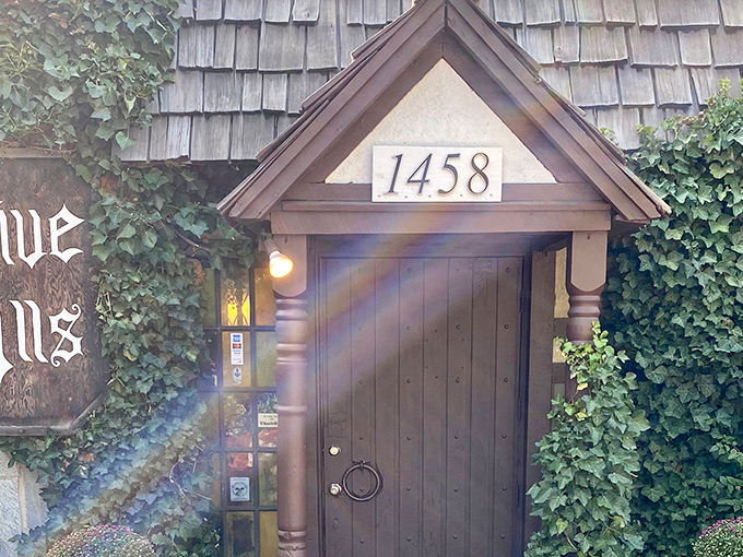 The entrance to Five Alls feels like a portal to medieval England, complete with ivy-covered walls and a door that practically begs you to say "Open sesame!"