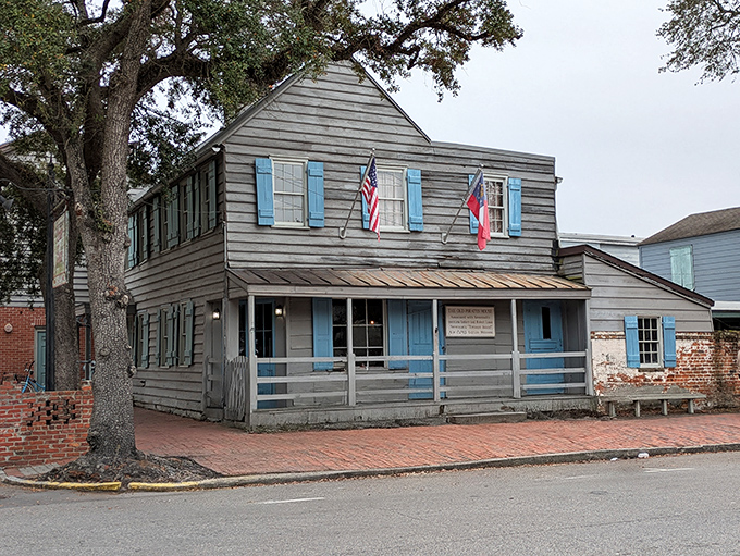 The historic blue-shuttered facade of The Pirates' House stands as a Georgian time capsule, welcoming hungry travelers just as it has since 1753.