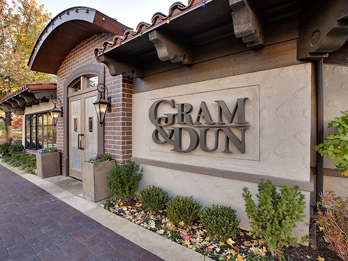 The entrance to Gram & Dun beckons like an old friend with its warm brick façade and elegant signage—architectural foreplay for the culinary adventure that awaits inside.