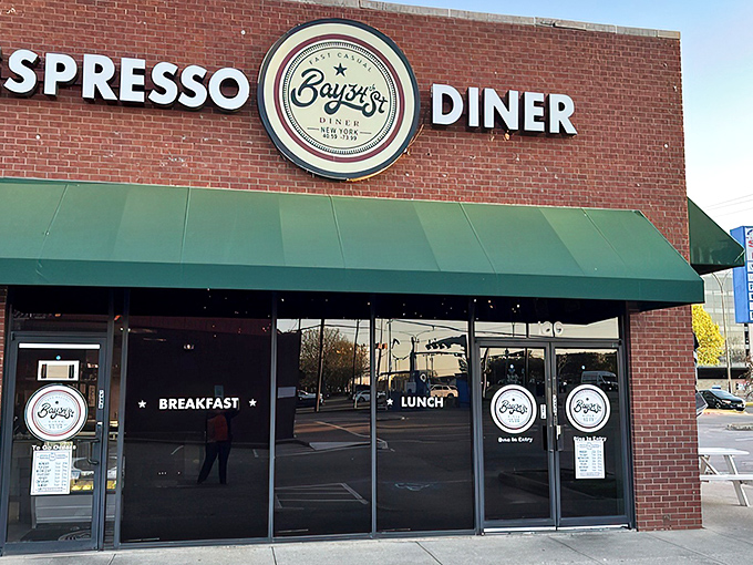 The brick facade with teal awnings isn't just inviting—it's practically shouting "Come get breakfast!" Those white picnic tables are waiting for your morning revelation.