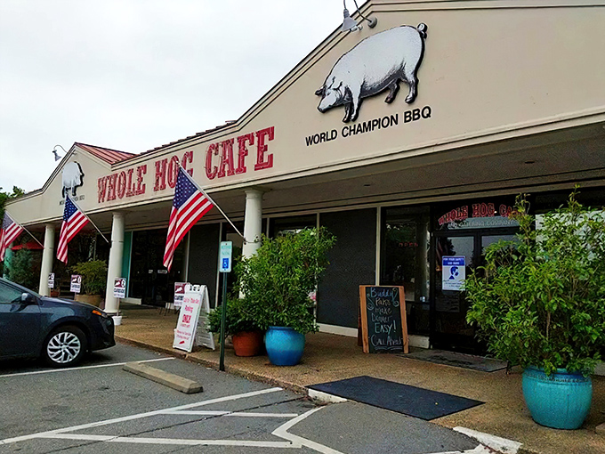 The promise of BBQ bliss beckons from this unassuming storefront. Whole Hog's iconic red sign stands like a carnivore's North Star against Arkansas skies.