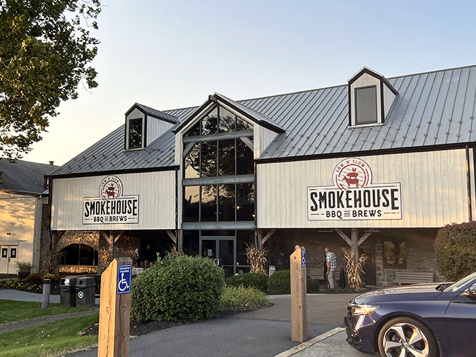 The barn-inspired exterior of Smokehouse BBQ & Brews stands proudly against the Pennsylvania sky, a beacon of smoked meat salvation in Amish Country.