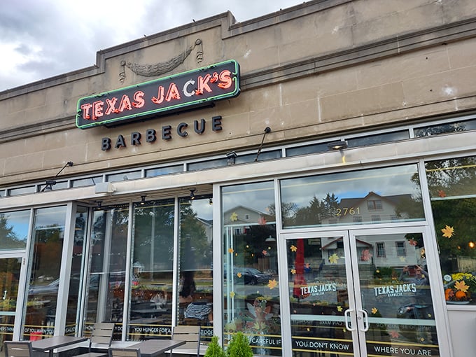 The inviting exterior of Texas Jack's Barbecue beckons with its vintage-style neon sign—like a beacon of smoky salvation on Arlington's Washington Boulevard.