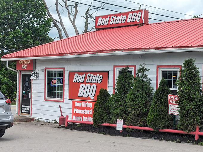 The modest white building with its bright red trim doesn't need fancy architecture—it lets the heavenly aroma of slow-smoked meats do all the talking.