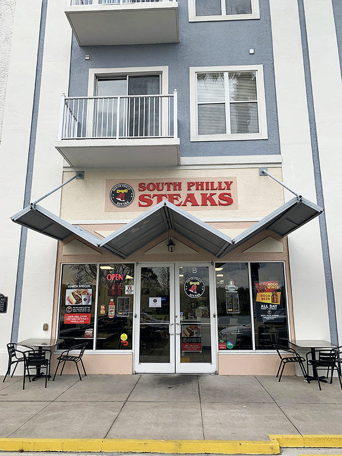 The bright red sign beckons like a lighthouse for the hungry—South Philly Steaks standing proud against Florida's sunny backdrop.