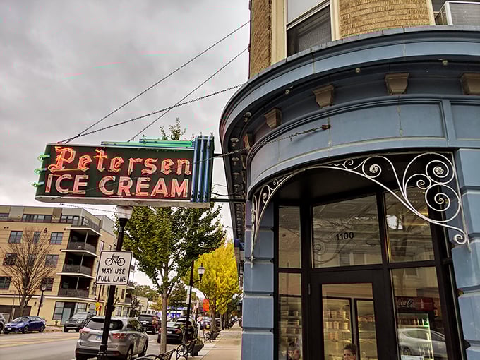 That neon sign doesn't just advertise ice cream—it's a beacon of hope on a tough day and a promise of something wonderful around that curved corner entrance.