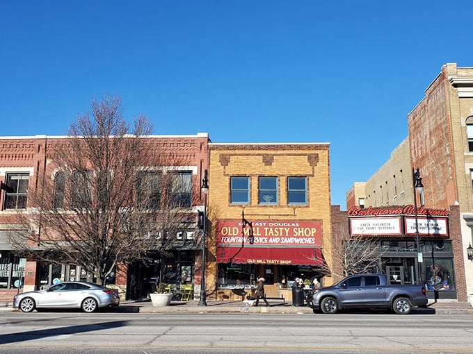 The yellow brick façade and classic red awning of Old Mill Tasty Shop isn't just a storefront—it's a time machine disguised as a downtown Wichita landmark.