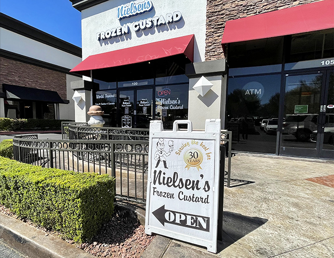 Welcome to frozen custard nirvana! Nielsen's storefront beckons with retro charm and a giant ice cream cone sculpture that's practically winking at you.