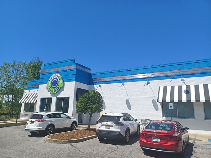 The blue and white exterior of The Blue Plate stands out like a beacon of hope for hungry travelers. This unassuming building holds culinary treasures within.