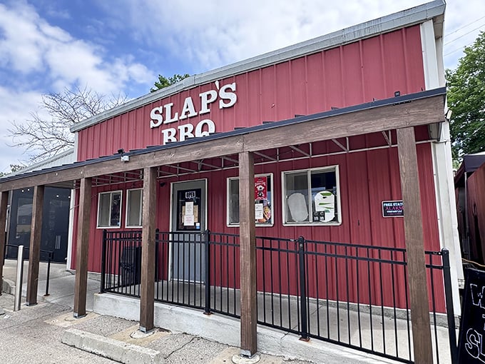 The iconic red exterior of Slap's BBQ stands as a beacon of hope for hungry pilgrims seeking smoky salvation in Kansas City's competitive barbecue landscape.