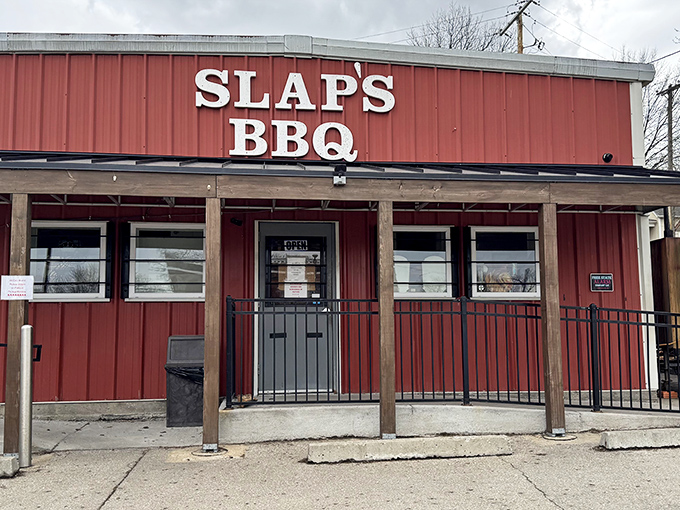 The iconic red exterior of Slap's BBQ stands as a beacon of hope for hungry pilgrims seeking smoky salvation in Kansas City's competitive barbecue landscape.